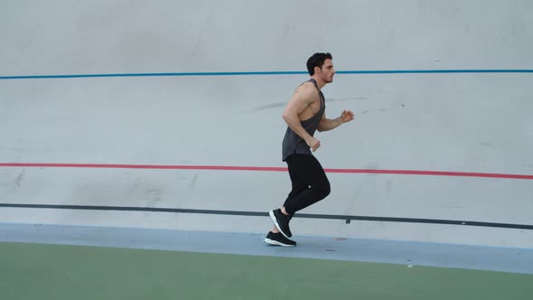 Sport Man Running in Slow Motion on Track. Man Runner Jogging on ...