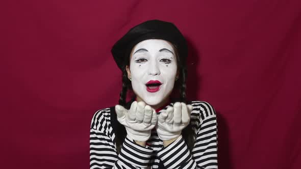 Beautiful Girl Mime Sends Air Kiss and Smiles Looking at the Camera ...