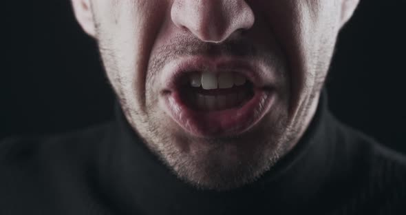 Closeup of Aggressive Man's Mouth Screams and Threatens with Violence ...