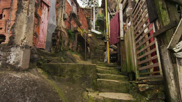 Tracking shot of shanties along the stairs in a favela in Rio de ...