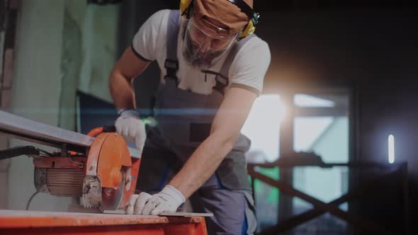 Ceramic Worker Uses Electric Tile Cutter in Construction Studio, Stock ...