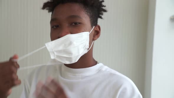 Young African Man Take Off Face Mask Removing From Face, Stock Footage