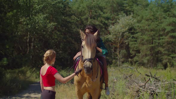 Woman Getting Off Saddle After Horseback Ride, Stock Footage | VideoHive