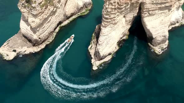 Overhead Shot Of Small Boat Passing Between Two Huge Pigeon Rocks In ...
