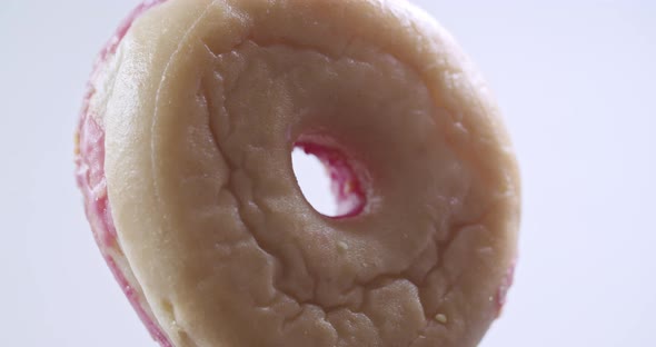 Close up shot of a donut spinning vertically in the frame. Strong ...