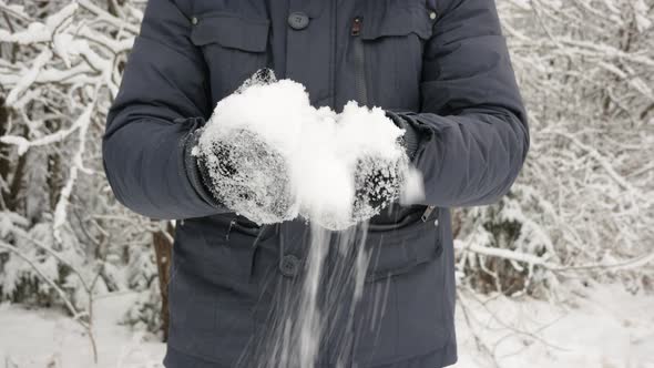 Snow in the hands. man holding snow in his hands in winter, Stock Footage