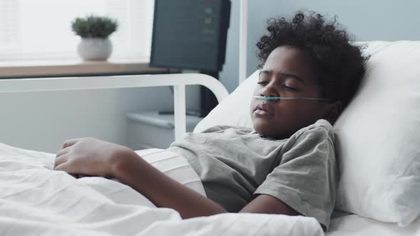 Boy with Oxygen Tube in Hospital Bed, Stock Footage | VideoHive