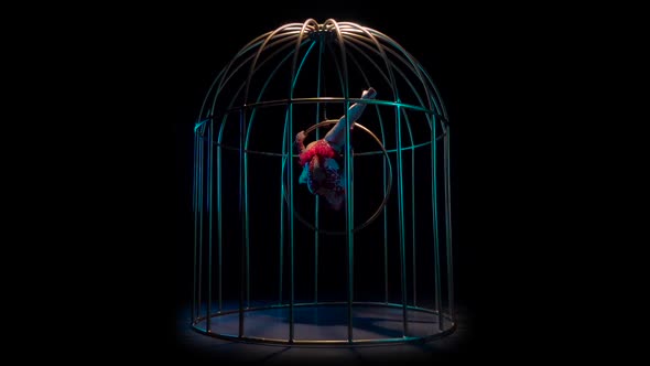 Art Acrobatics on a Spinning Hoop in a Cage. Black Background. Slow ...