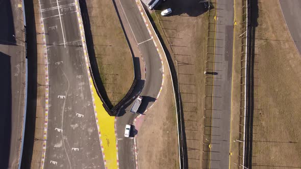 Aerial top down shot of trucking towing away race car after accident on ...