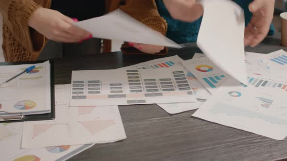 Close Up of Colleagues Checking Papers with Data Rate Charts, Stock Footage