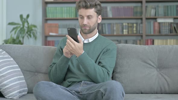 Excited Young Man Checking His Phone and Celebrating, Stock Footage