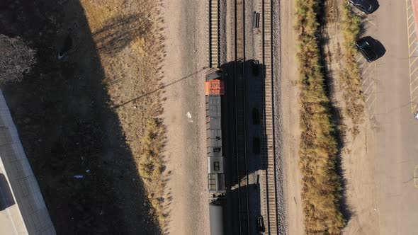 An idle train rests along a busy freeway, Stock Footage | VideoHive
