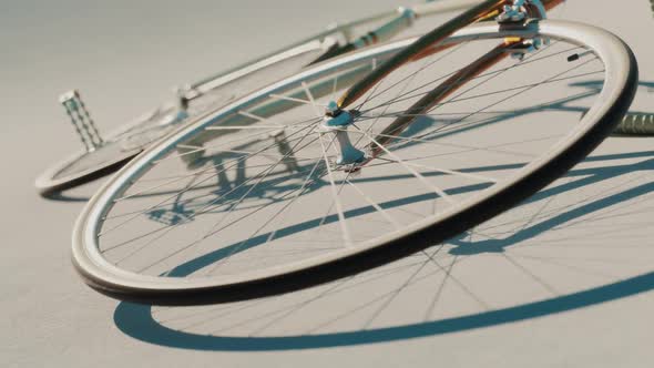 Retro bicycle lying on concrete road. Spinning wheel. Endless looping ...
