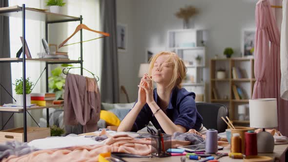 Young Woman Designer Tired While Working on a New Dress, Stock Footage