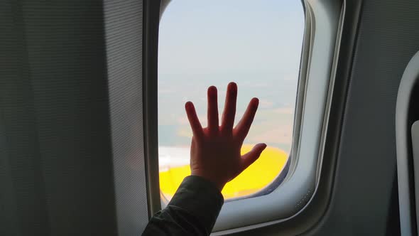 Child Travels By Plane Little Boy Holds His Hand on Plane Window During ...