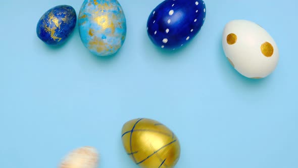 Easter Eggs are Rolling Knocking Each Other on Blue Table, Stock Footage