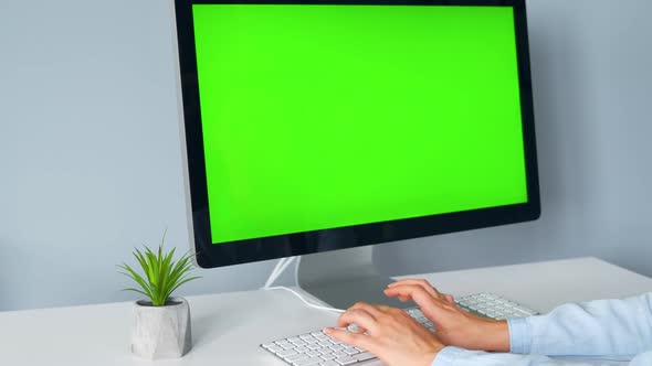 Woman Typing on a Computer Keyboard, Monitor with a Green Screen ...