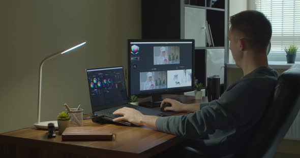 Man Working on Computer with Two Monitors Color Correction Post ...