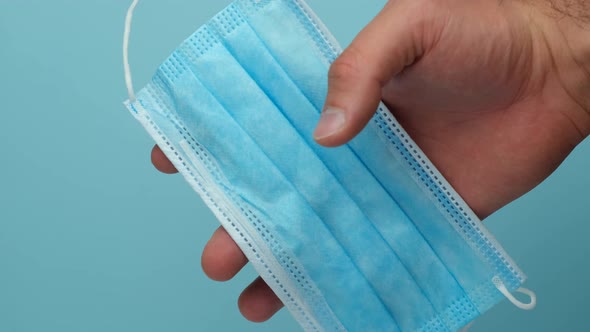 Man Crumpling the Used Disposable Face Mask and Throwing Out It, Stock ...