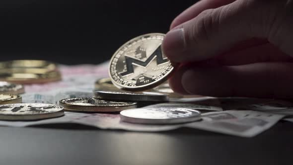 Presenting Monero coin on other coins and Czech banknotes, close up ...