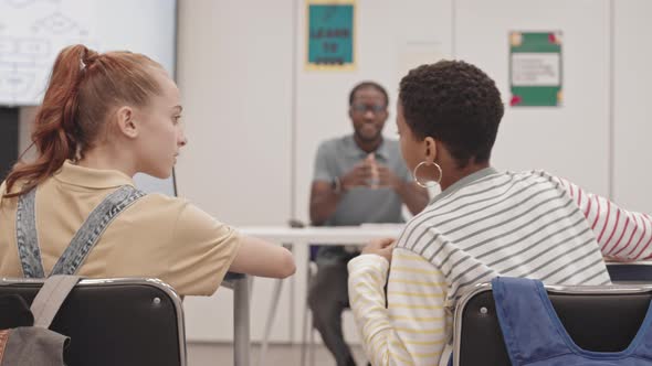 Diverse Students Whispering in Class, Stock Footage | VideoHive