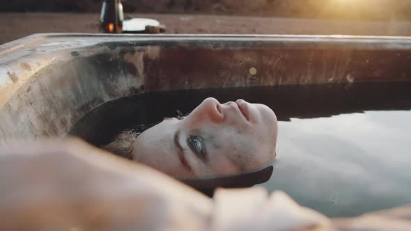 Woman Lying in Dirty Water in Rusty Bath in Dystopian World, Stock Footage