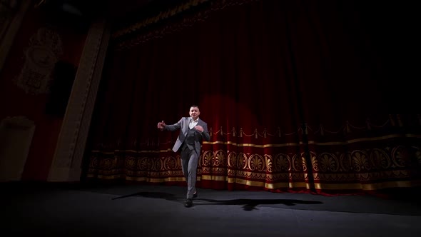 Man on stage in theater. Man speaking on stage of theatre, Stock Footage
