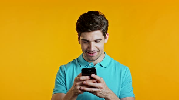 Handsome Man Texting in Messenger. Guy Sighs. Yellow Studio Background ...