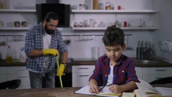Lovely Son Doing Homework While Dad Mopping Floor, Stock Footage ...