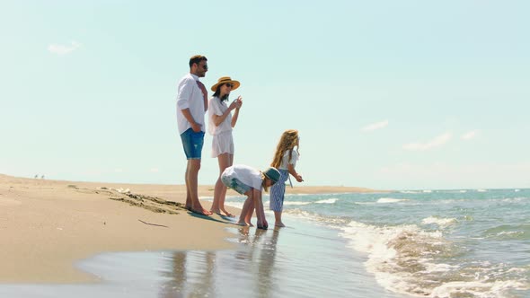 Children throwing wet sand into water, Stock Footage | VideoHive