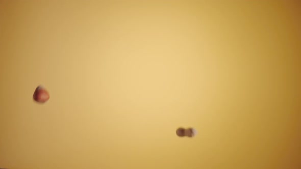 Explosion of Dried Unpeeled Peanuts and Kernel Hazelnuts on Yellow ...