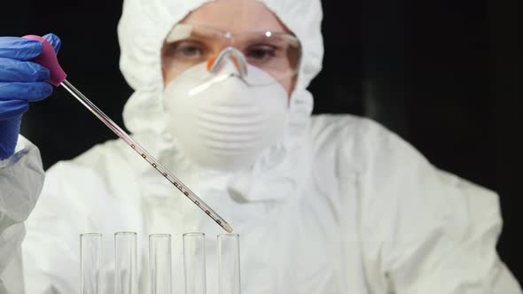 A Man in a Biological Protection Suit Works in a Lab, Stock Footage