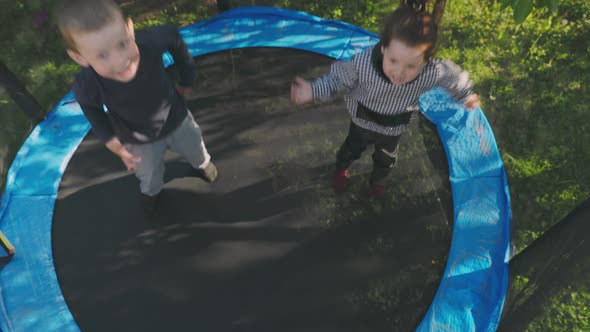 Two Children Have Fun Jumping on a Trampoline, Stock Footage | VideoHive