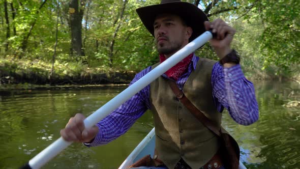Cowboy in a Canoe Floats on the River, Stock Footage | VideoHive