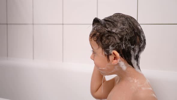 Mom Washes Her Son's Hair with Baby Shampoo in the White Bathroom ...