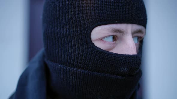 Closeup Face of Suspicious Caucasian Man in Ski Mask Looking Around and ...