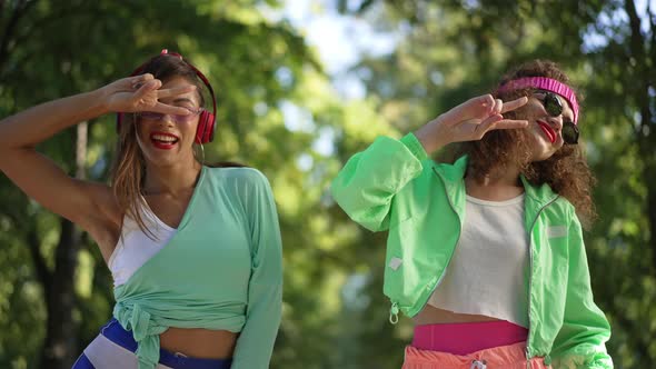 Two Joyful Retro Women Dancing in Slow Motion in 1990s Outdoors Having ...
