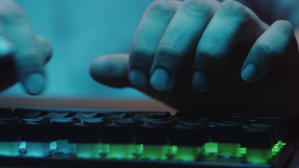 Gamer Typing on Backlight Keyboard Closeup Man Playing Video Game ...