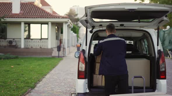 Young Handsome Caucasian Delivery Man Putting Boxes in Van Delivering ...