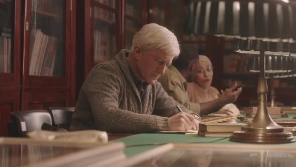 University Professor Working in Library, Stock Footage | VideoHive