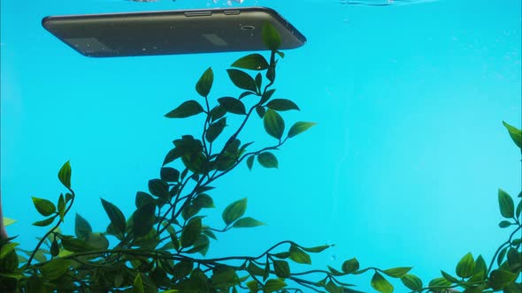 Falling Smartphone at Bottom of Ocean Closeup Waterproof Gadget Sinking ...