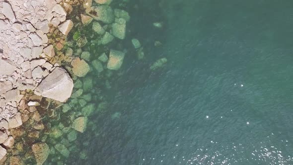 Overhead view of boulders in sea water at Torquay England., Stock Footage