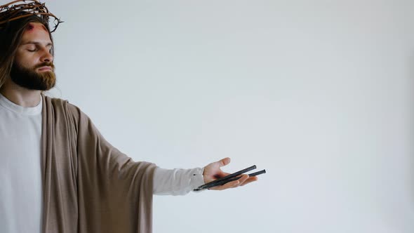 Jesus' Hand with Stigma Holds a Crucifixion Nail on a White Background ...