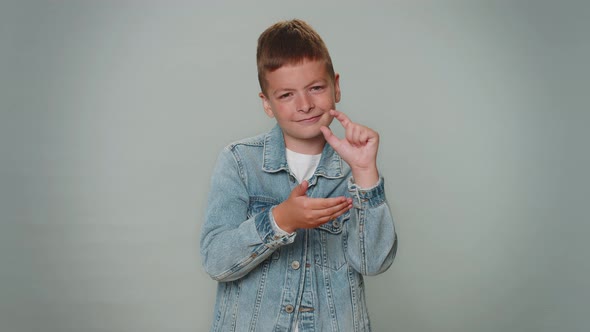 Boy Showing a Little Bit Gesture with Sceptic Smile Showing Minimum ...