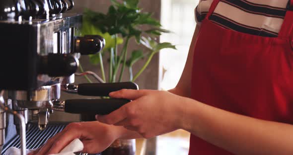 Waitress wiping espresso machine with napkin in caf , Stock Footage