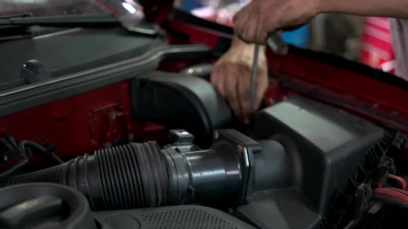Repairman Unscrewing and Withdrawing Big Car Engine Detail, Stock Footage