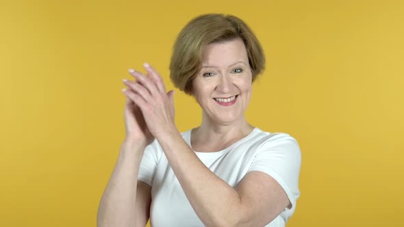 Clapping Old Woman, Applauding Isolated on Yellow Background, Stock Footage