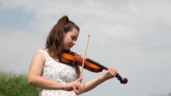 Woman Playing Violin in Nature, Stock Footage | VideoHive