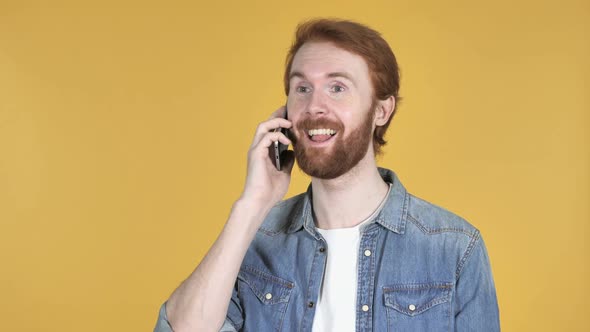 Redhead Man Talking on Smartphone Yellow Background, Stock Footage
