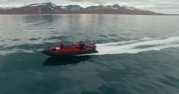 Aerial View of the Red Speed Boat with Two People on It Rushing Over ...